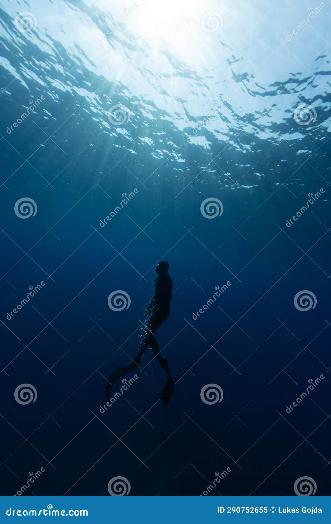 Freediver Swimming in Deep Sea with Sunrays Stock Image - Image of ...
