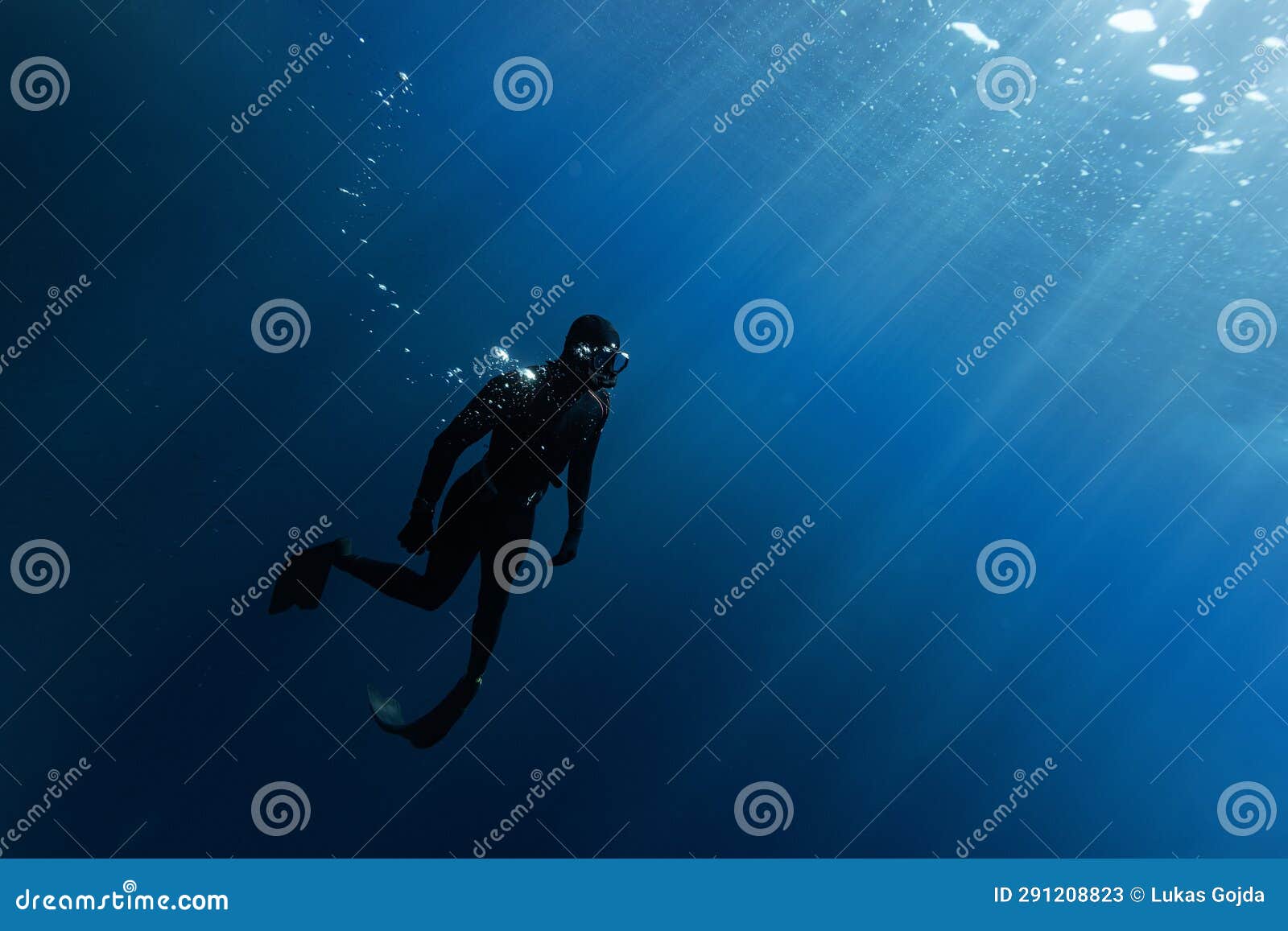 Freediver Swimming in Deep Sea with Sunrays Stock Image - Image of ...