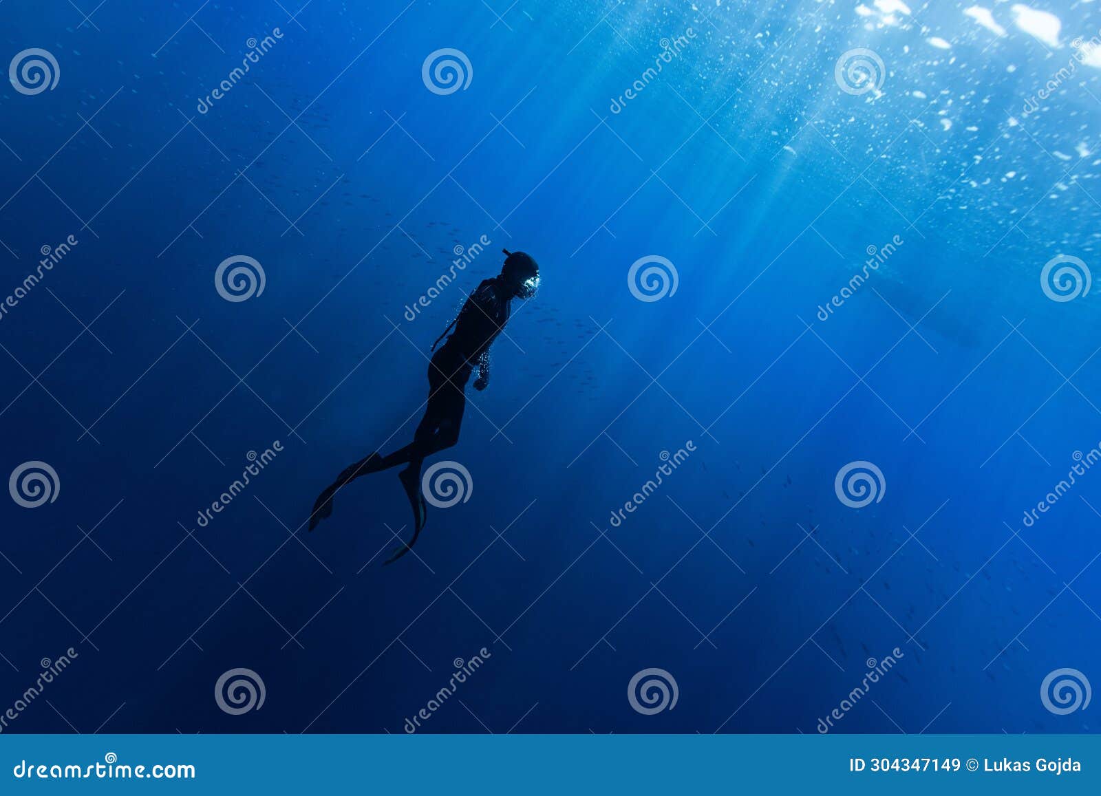 Freediver Swimming in Deep Sea with Sunrays Stock Image - Image of ...