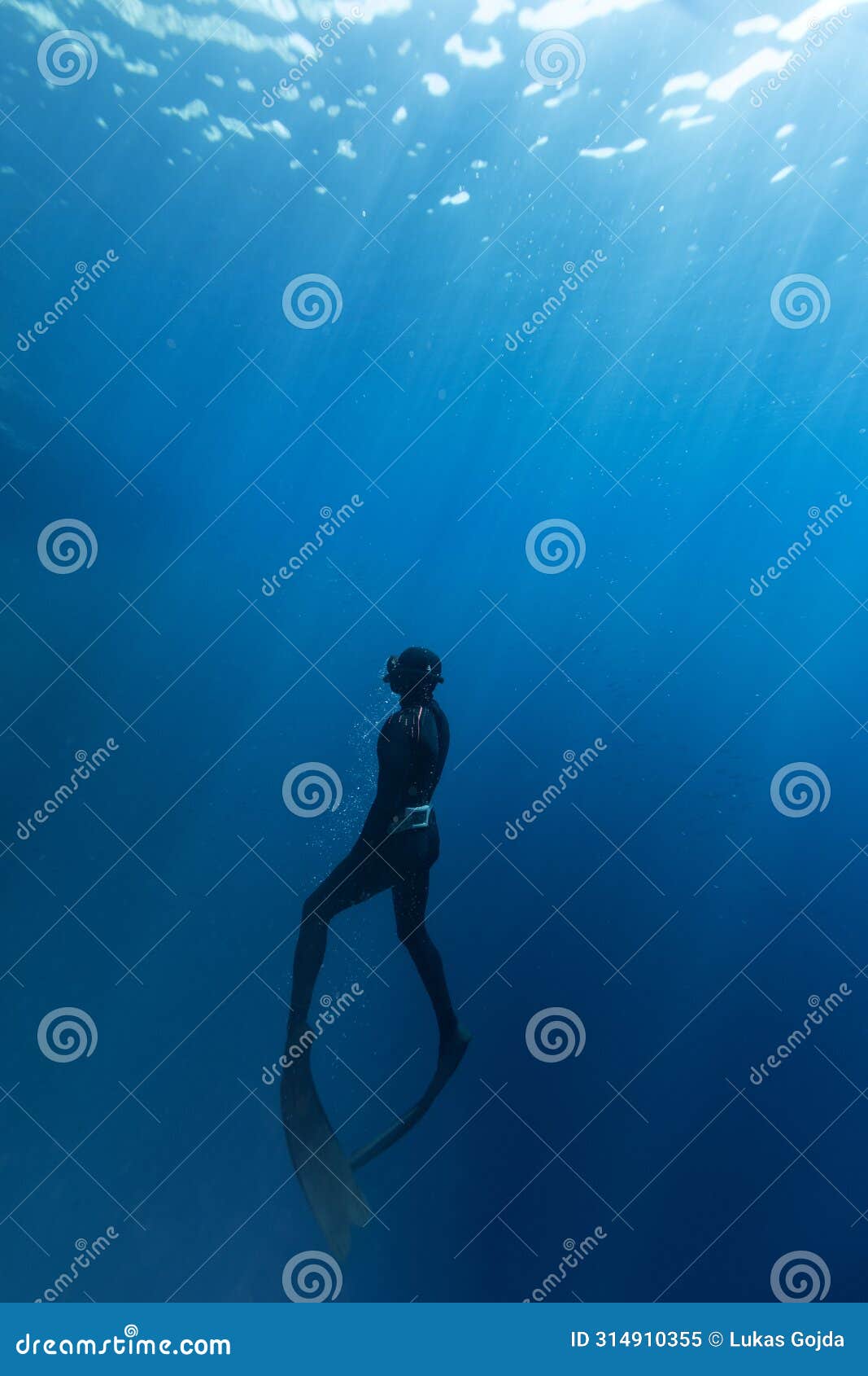 Freediver Swimming in Deep Sea with Sunrays Stock Image - Image of ...