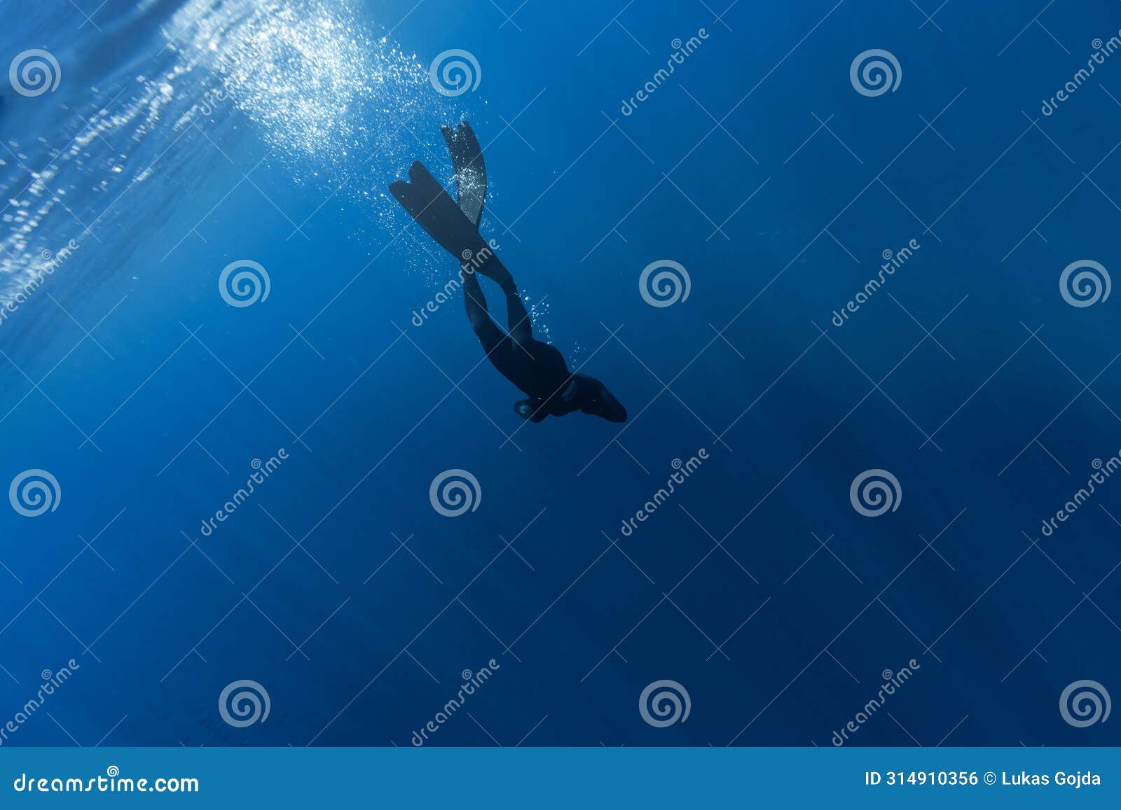 Freediver Swimming in Deep Sea with Sunrays Stock Photo - Image of ...