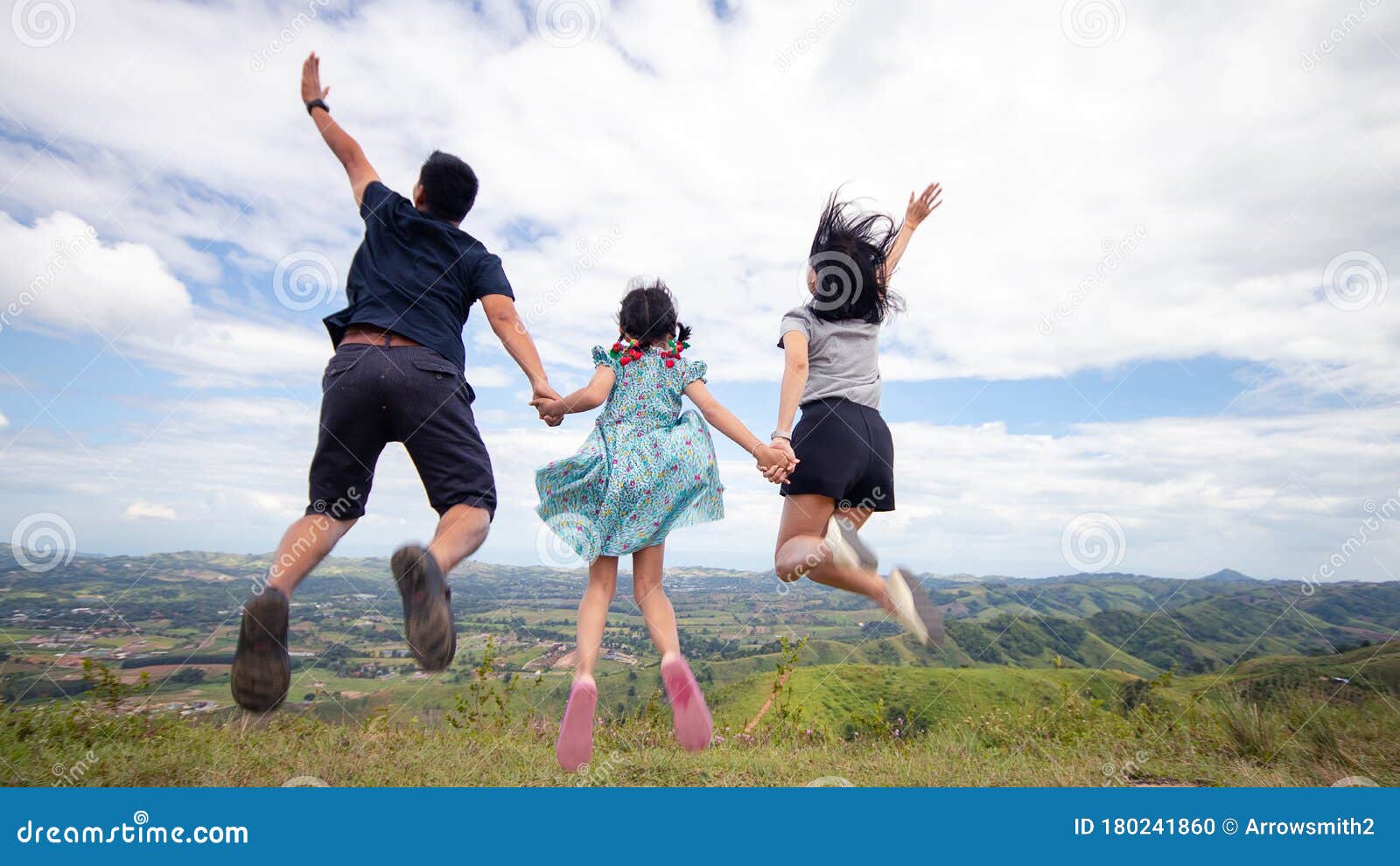 Freedom Active Family Jumping at the Top of Mountain Stock Photo ...