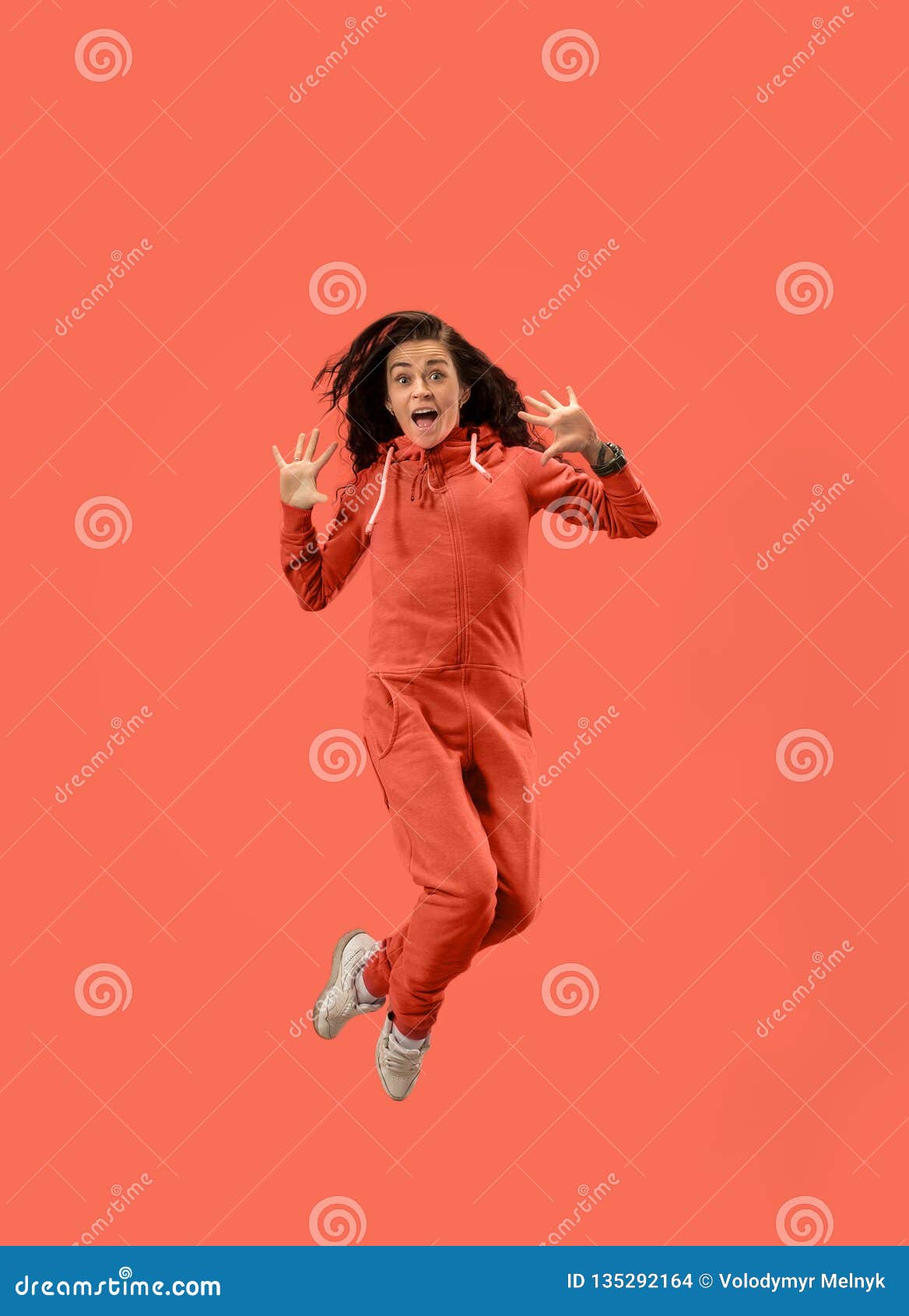 Freedom in Moving. Pretty Young Woman Jumping Against Coral Background ... Freedom in Moving. Pretty Young Woman Jumping Against Coral Background ...