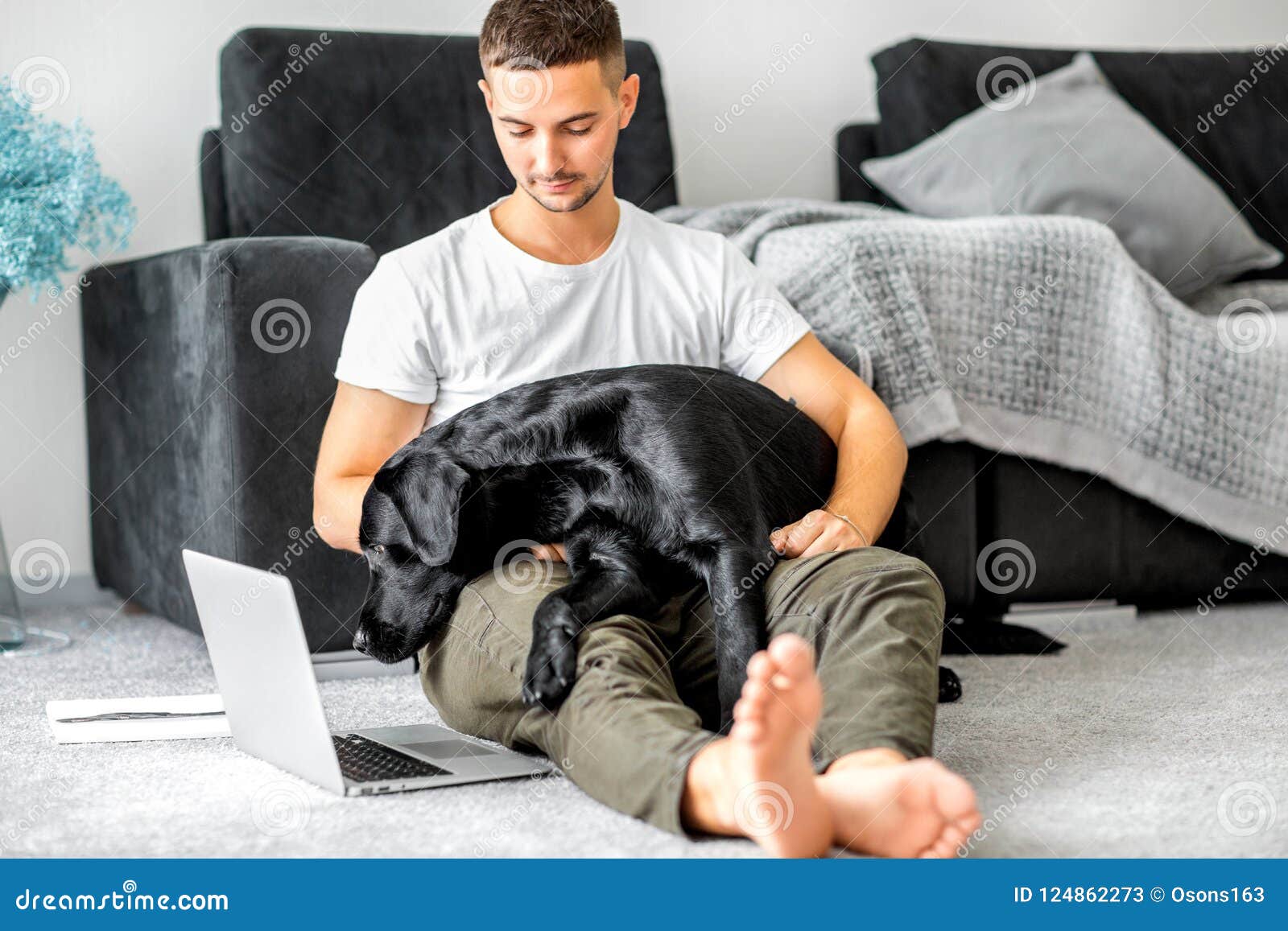 Freelancer Guy Sitting at Home Working with a Dog in an Embrace, Black ...