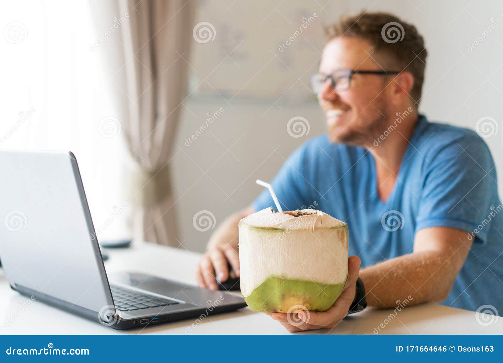 Freelancer Guy is Sitting in the Office Working and Drinking Coconut ...