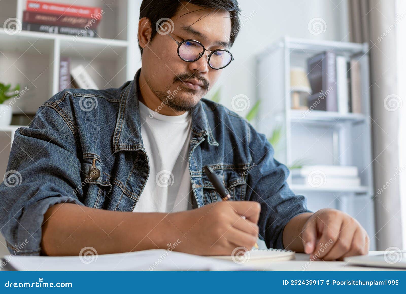 Freelancer Man is Planning Work or Writing Idea into His Notebook ...
