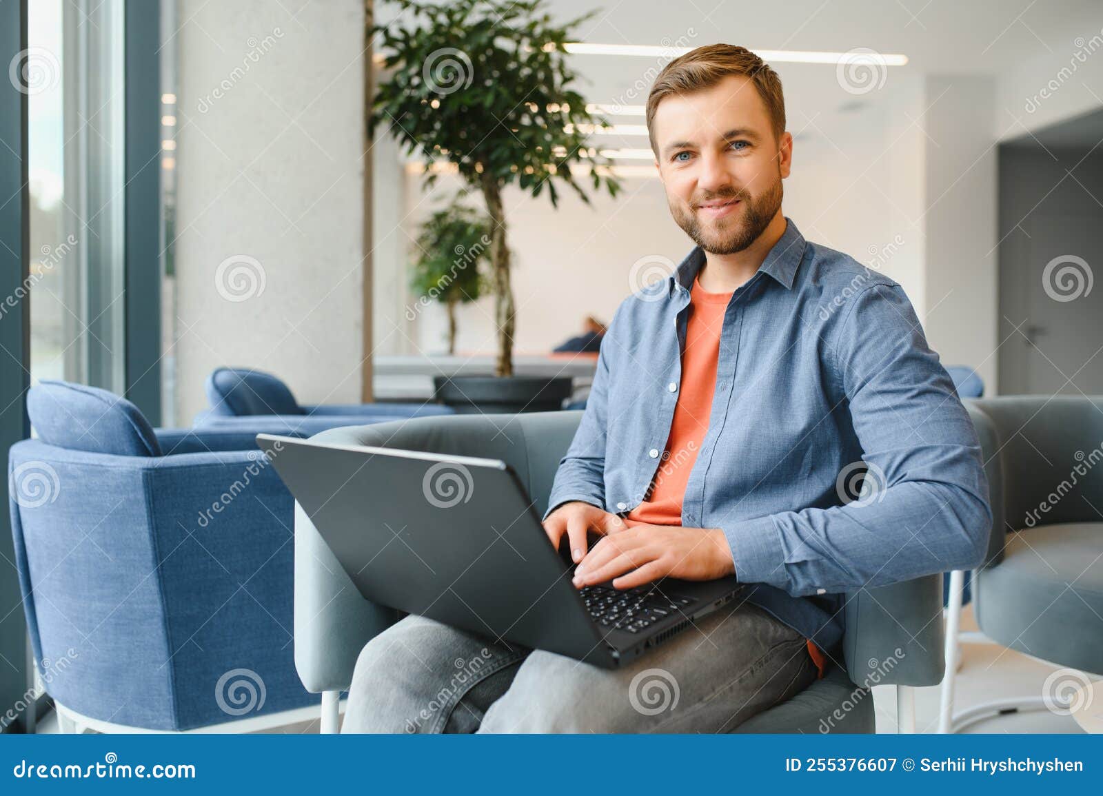 A Freelancer Man Works with a Laptop in a Work Coaching Office Stock ...