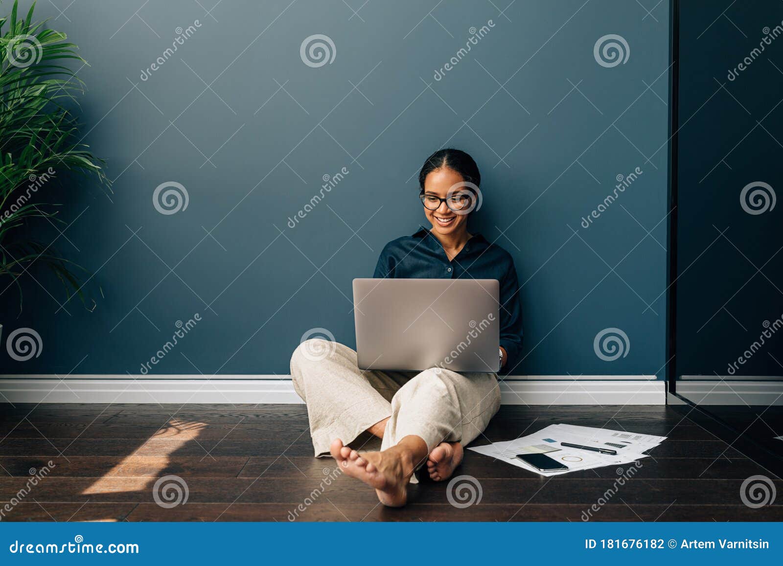 Freelancer Sitting on the Floor Working on a Laptop Stock Photo - Image ...