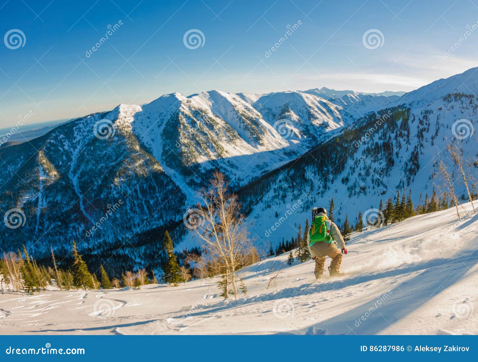 Freeride Snowboarder Slides Down a Steep Slope at Dawn Stock Photo ...