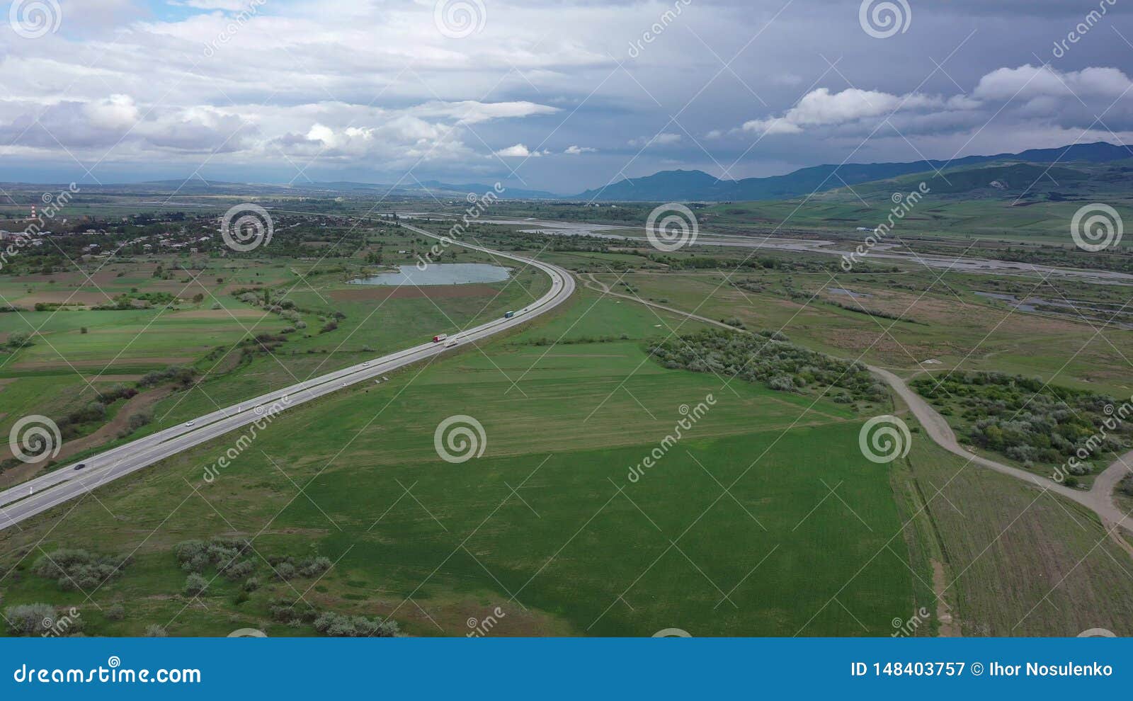 Freeway among green fields stock image. Image of asphalt - 148403757