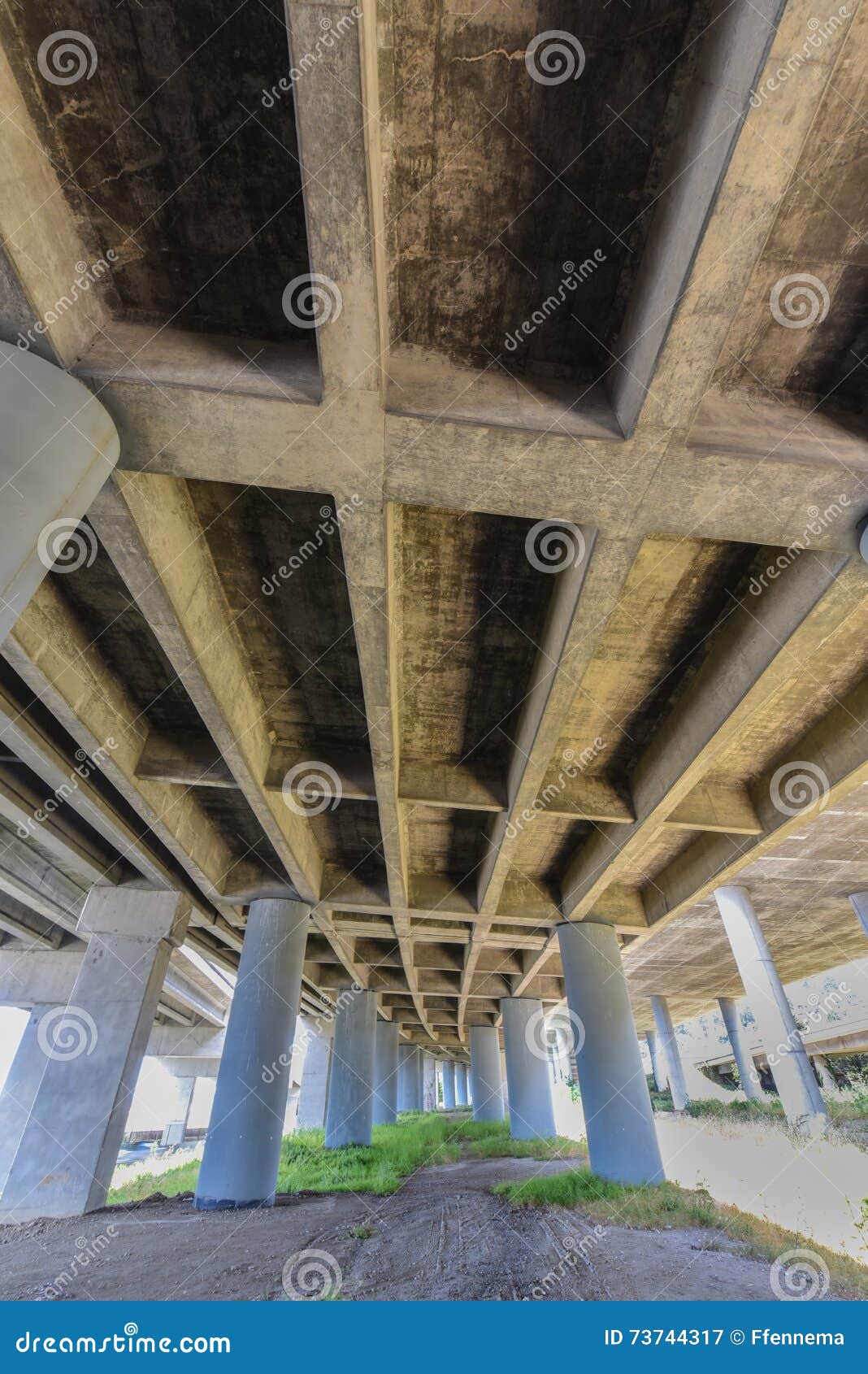 Freeway Underpass with Pillars and Grass Stock Image - Image of ...