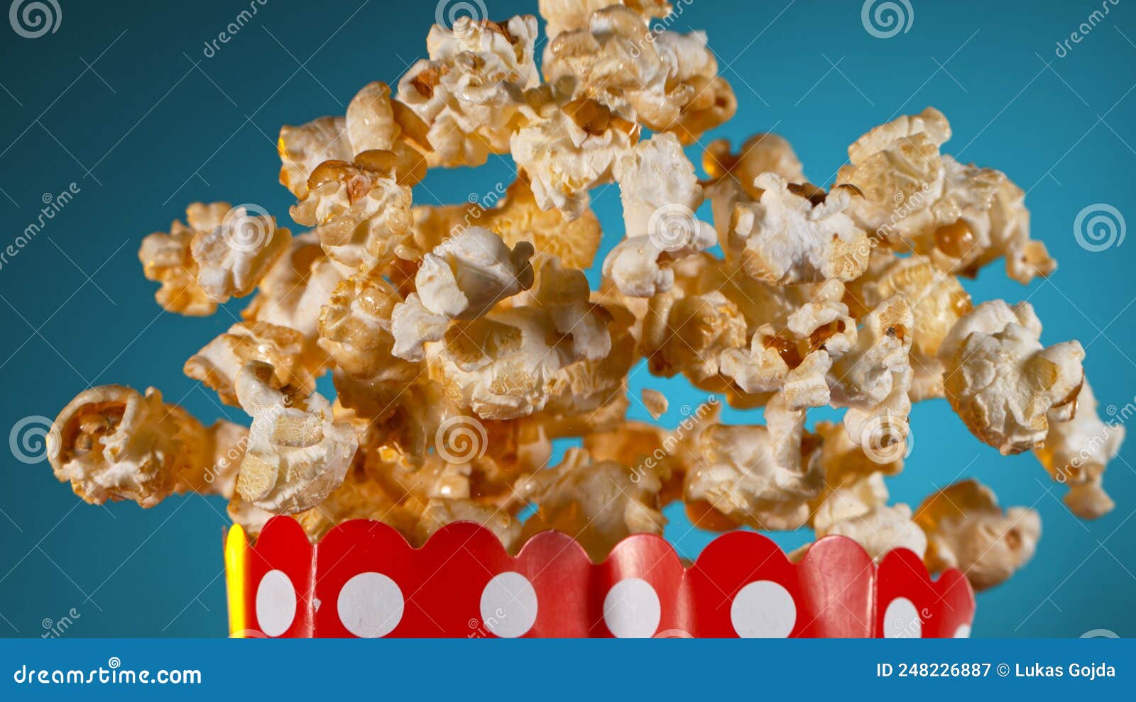 Freeze Motion of Popcorn Flying on Gradient Blue Background. Stock ...