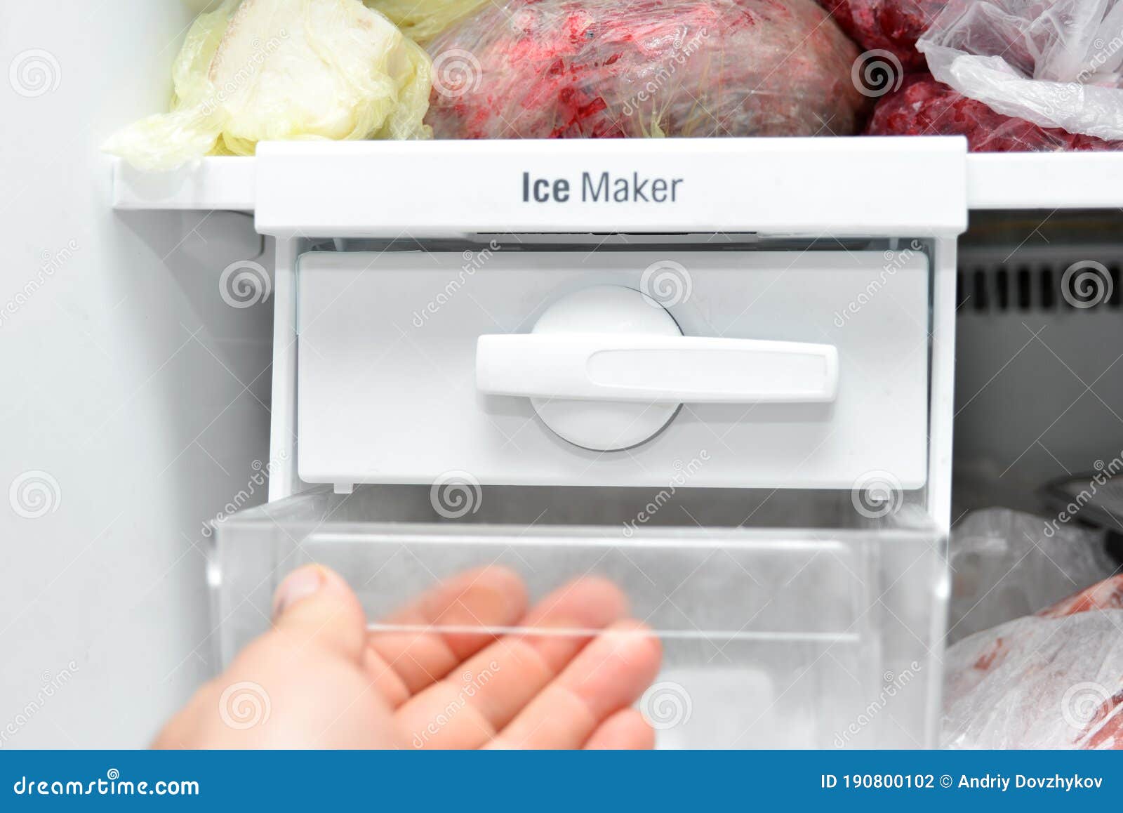 Freezer Ice Tray. a Man Takes Out Ice Cubes To Cool Drinks Stock Photo ...