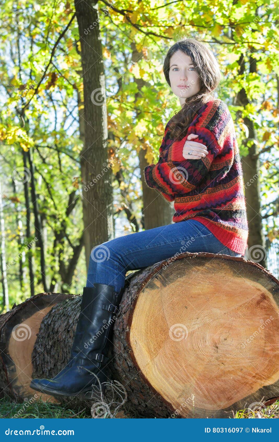 Freezing Woman Sitting on Sawn Tree Trunk and Hugging Herself Stock ...