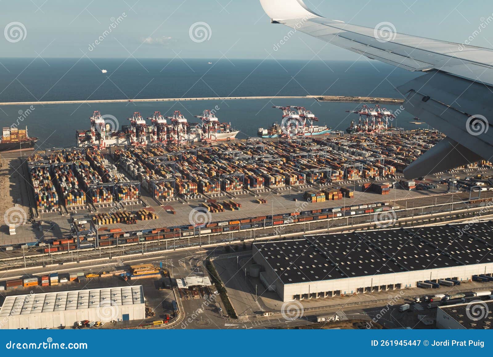 Freight Cargo Ship Loading on a Harbor Seen from an Airplane Wing Stock ...