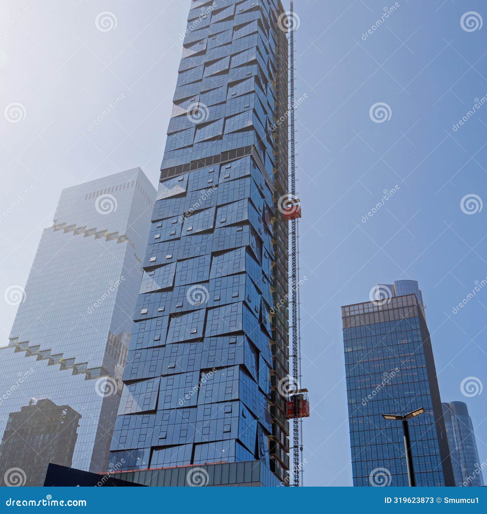 Freight Construction Elevator Ascends To Top of a Skyscraper. Temporary ...