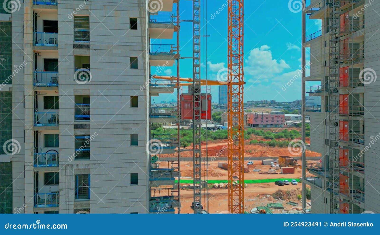 Freight Elevator at the Construction Site of High Rides Up and Down. a ...