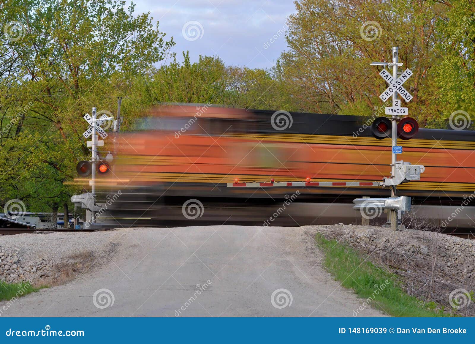 Freight Train in Motion at Crossing Gate Stock Image - Image of freight ...