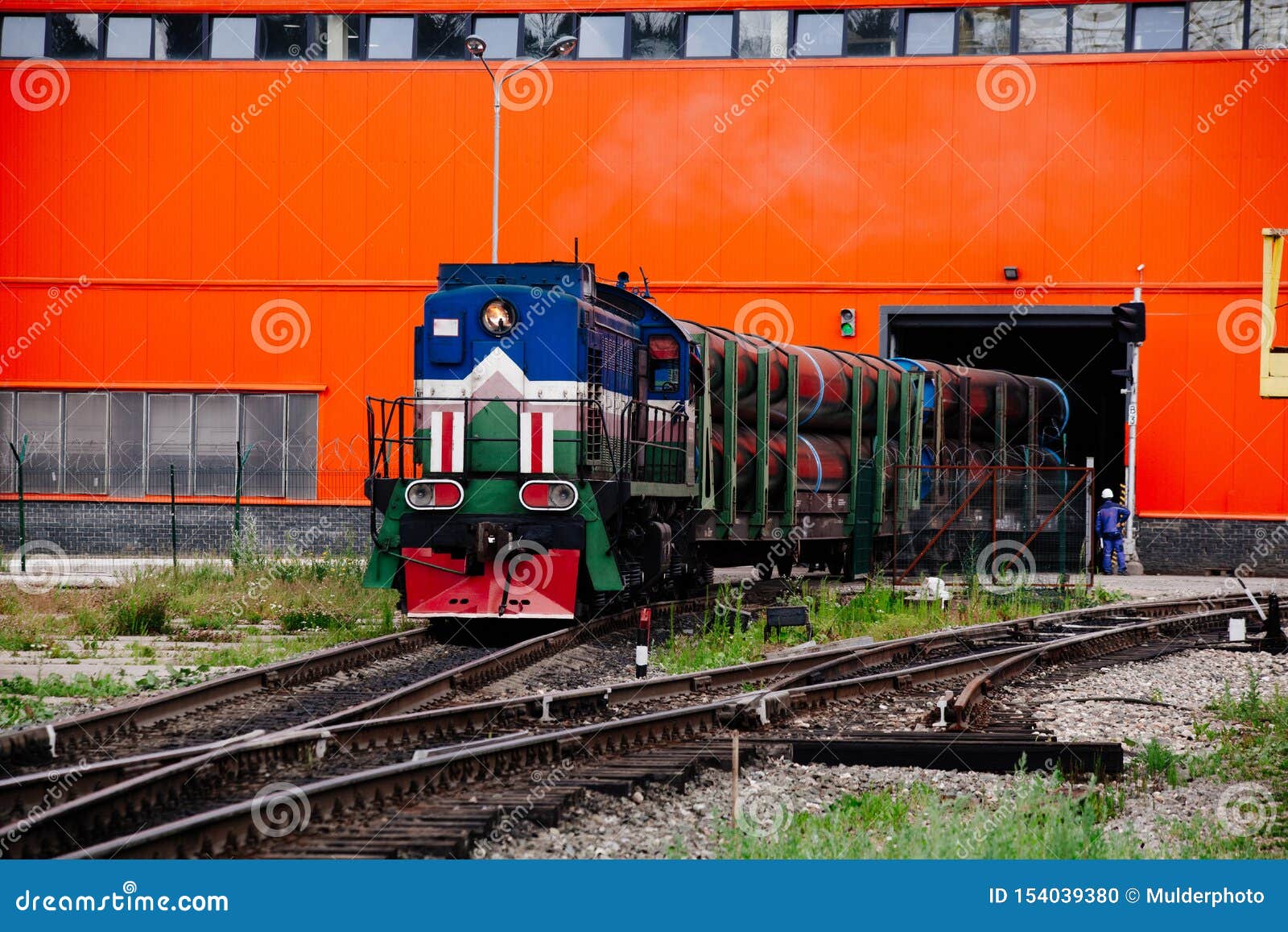 Freight Train with New Manufactured Pipes Exits from Warehouse Stock ...