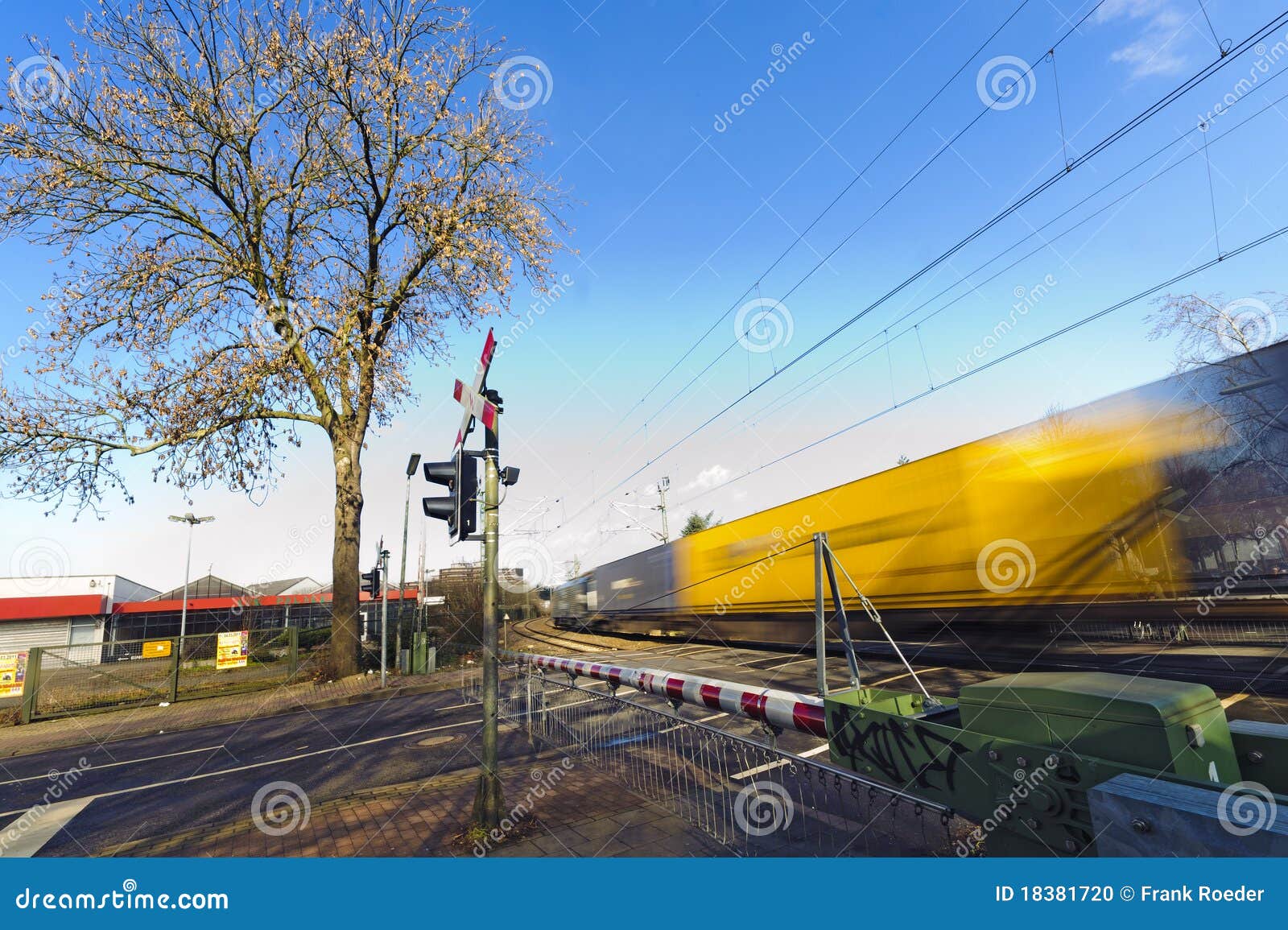 Freight Train at a Railroad Crossing Stock Photo - Image of street ...