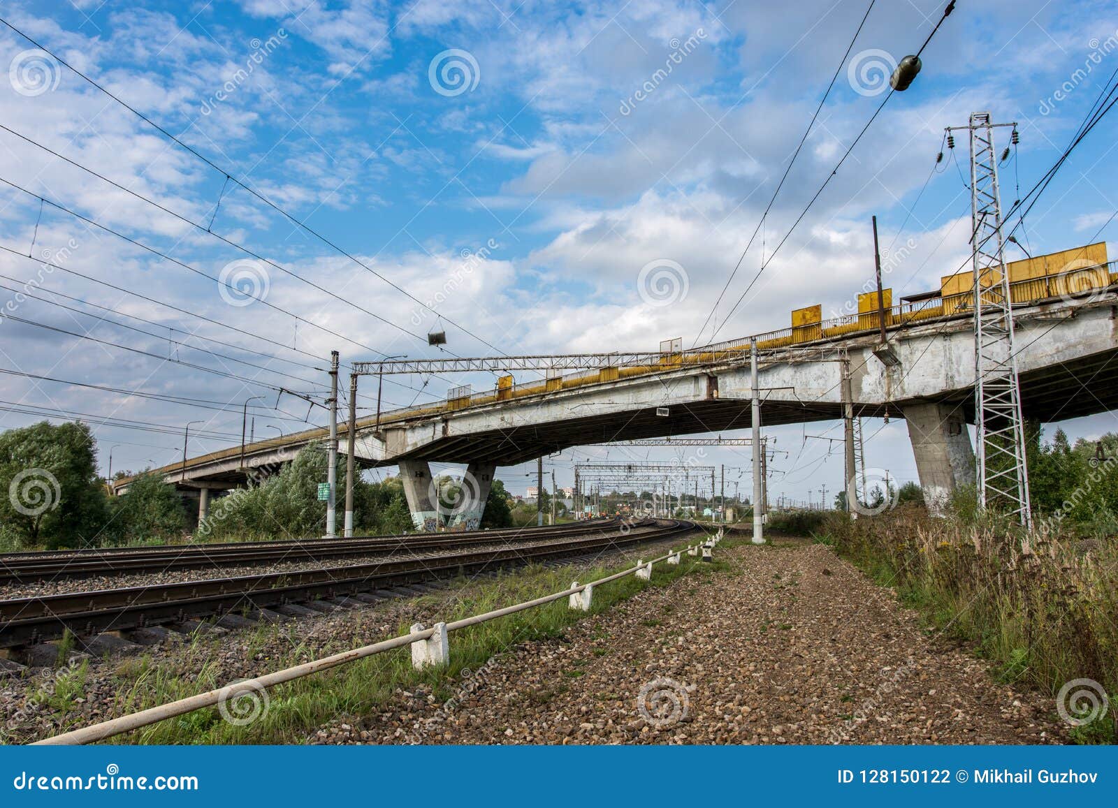 Freight Train Rides by Rail Under the Road Bridge Stock Photo - Image ...