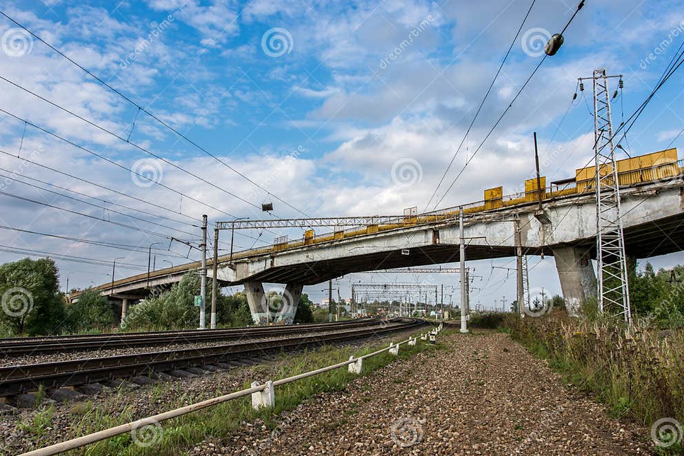 Freight Train Rides by Rail Under the Road Bridge Stock Photo - Image ...