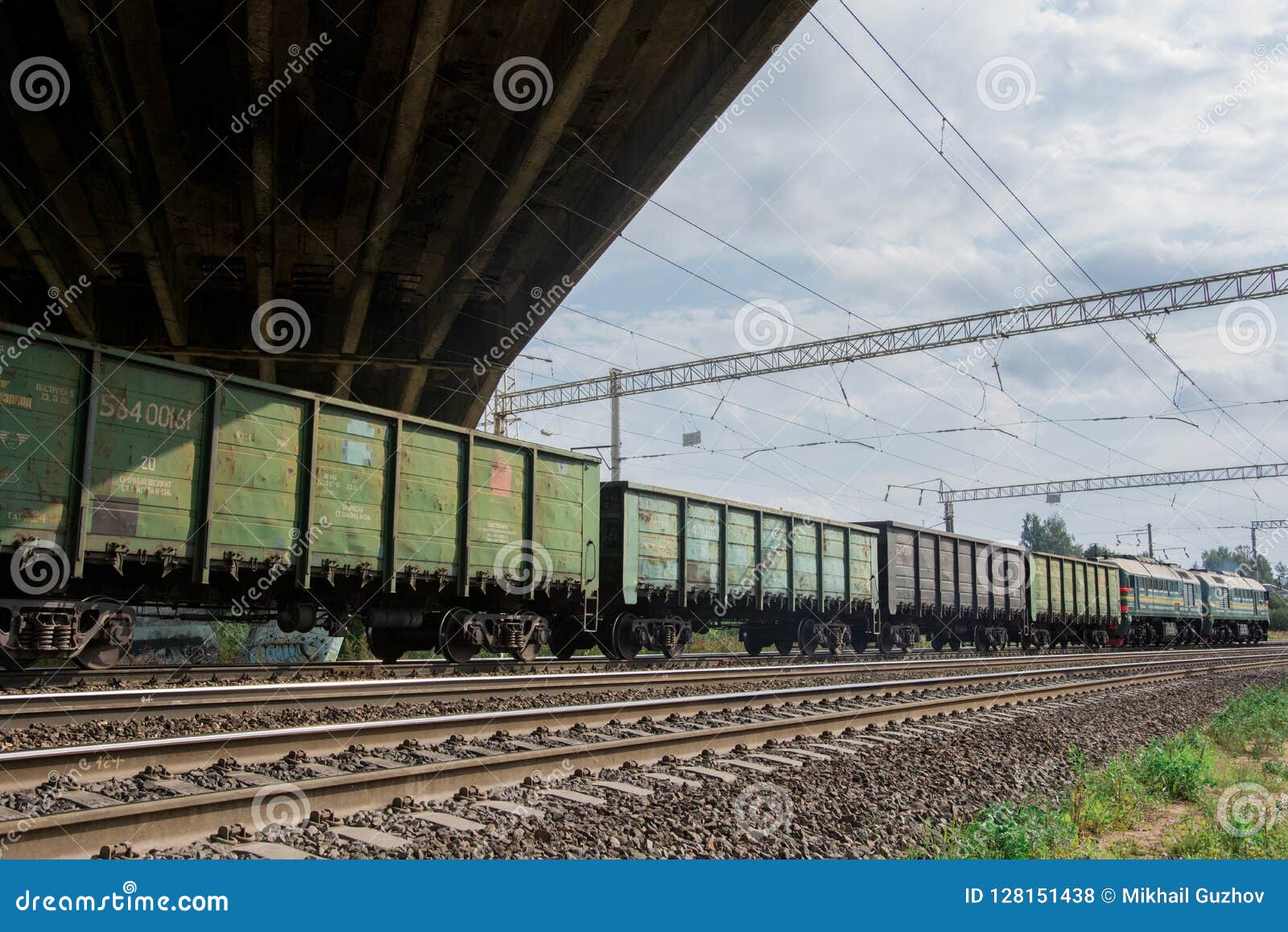 Freight Train Rides by Rail Under the Road Bridge Stock Photo - Image ...