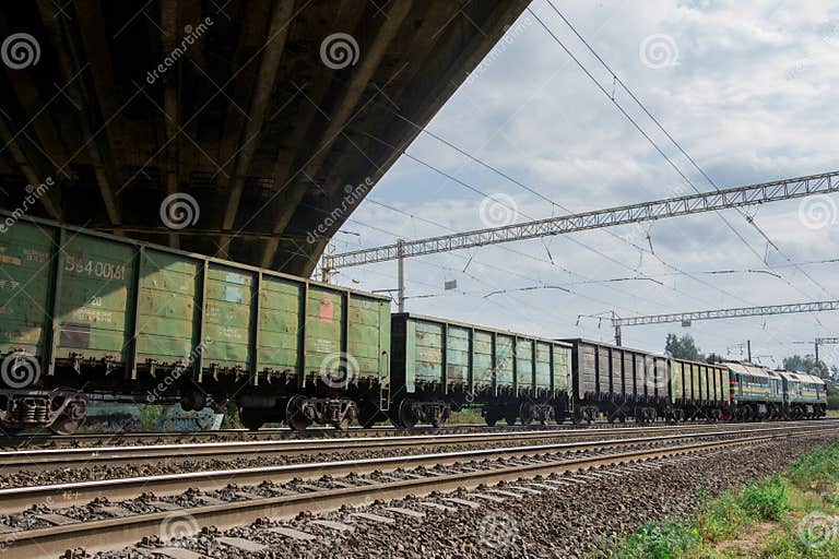 Freight Train Rides by Rail Under the Road Bridge Stock Photo - Image ...