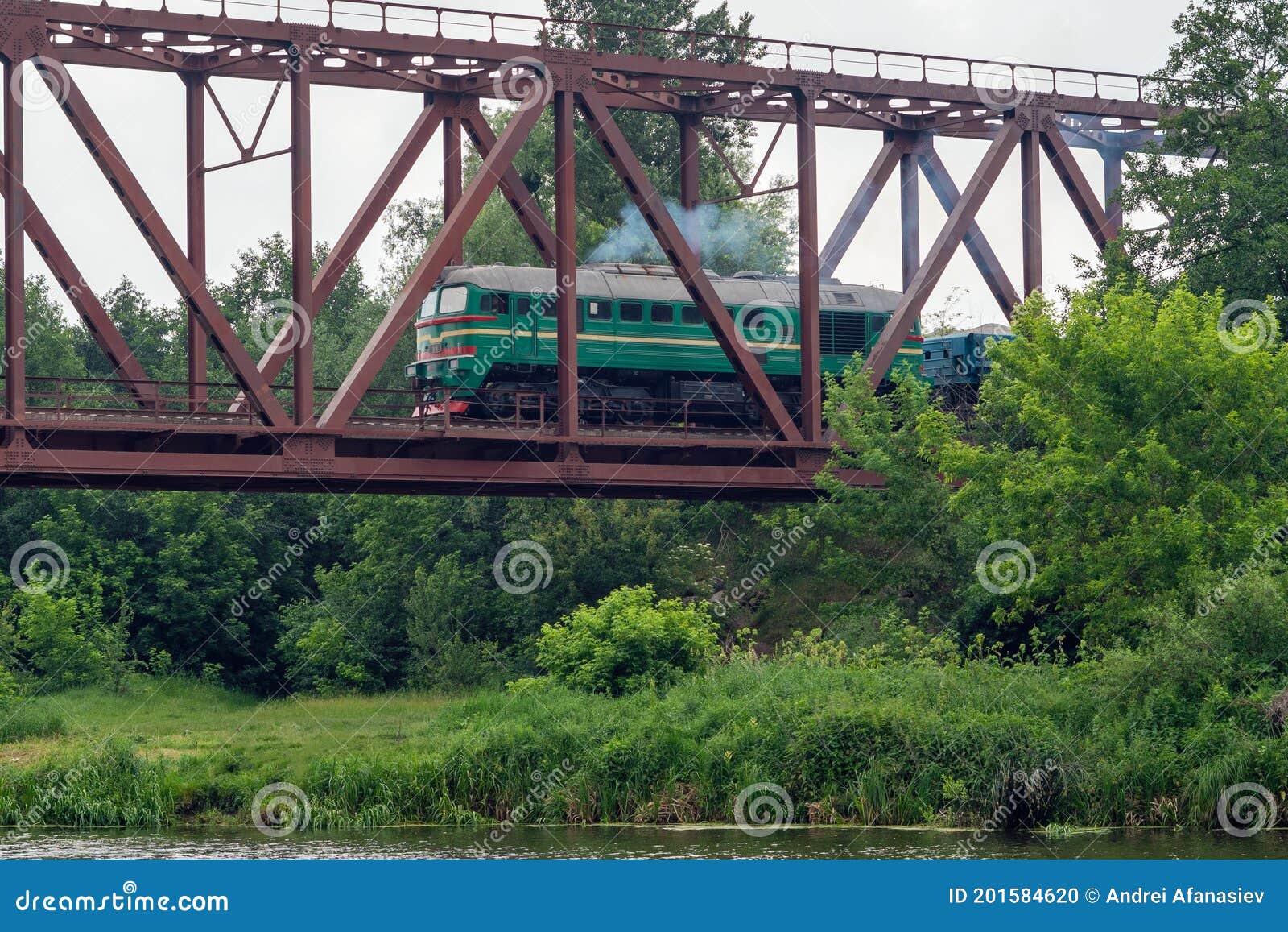 Freight Train Rides on a Railway Bridge Over the River Stock Photo ...