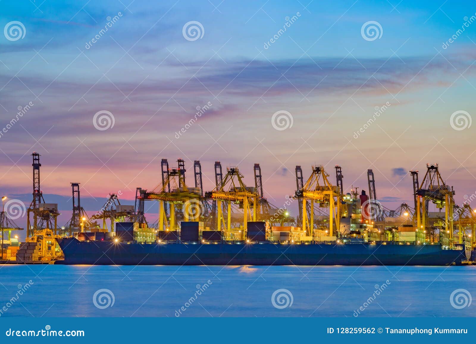 Freighter Ship Loading Cargo at Loading Dock on Twilight Time. Stock ...