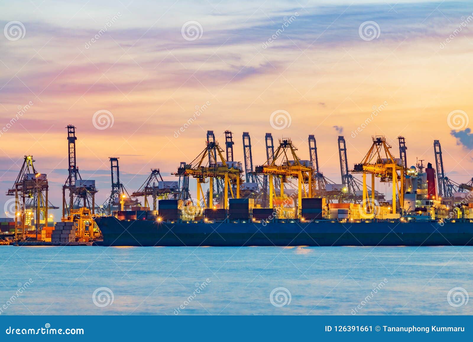 Freighter Ship Loading Cargo at Loading Dock on Twilight Time. Stock ...