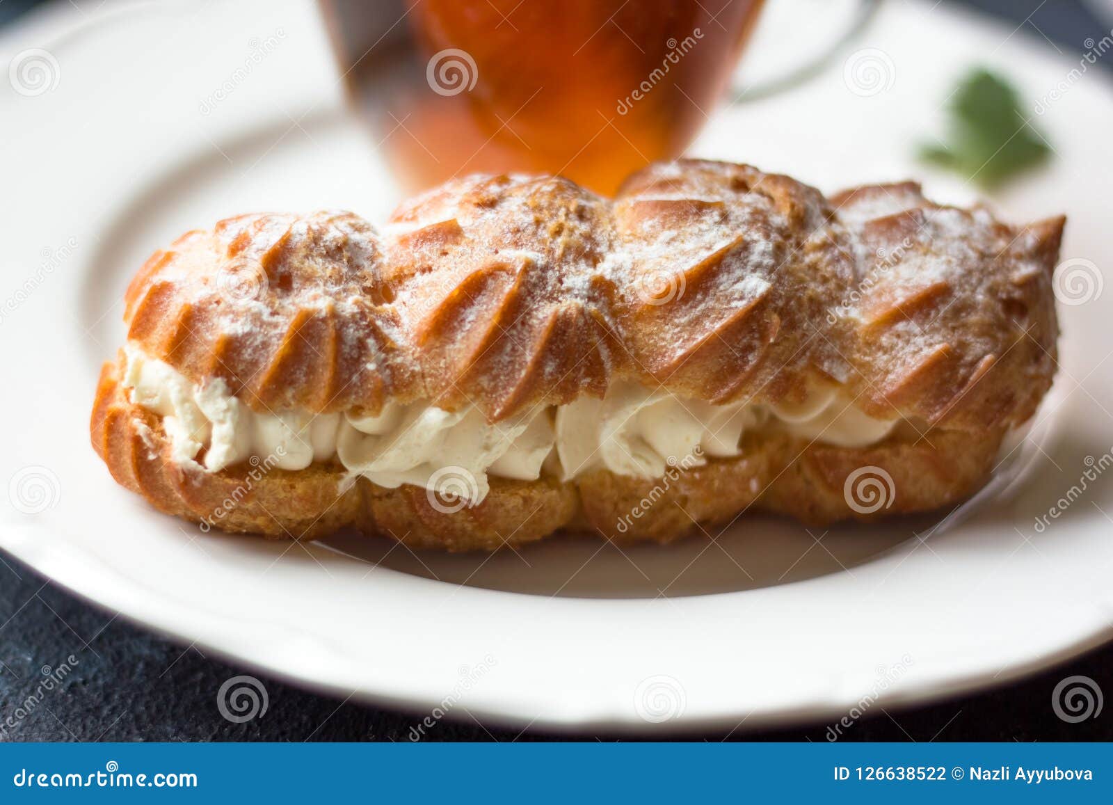 French Eclair Sweet on the Plate on the Table Stock Photo - Image of ...