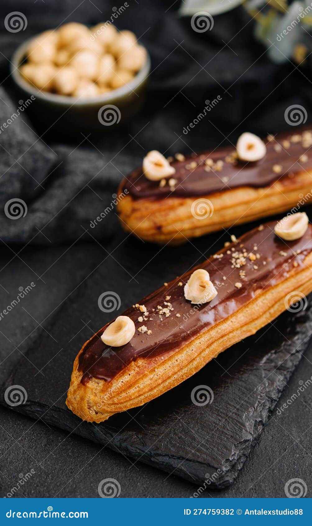 French Eclairs with Chocolate and Hazelnuts Stock Photo - Image of ...