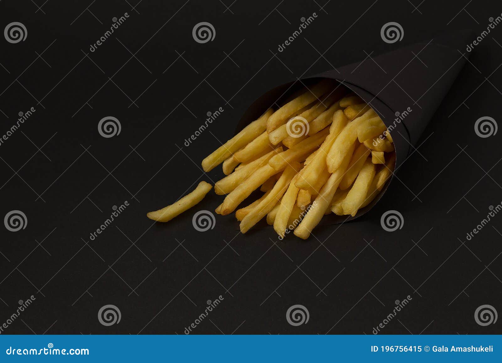 French Fries on a Black Background, in a Black Package, Horizontal ...