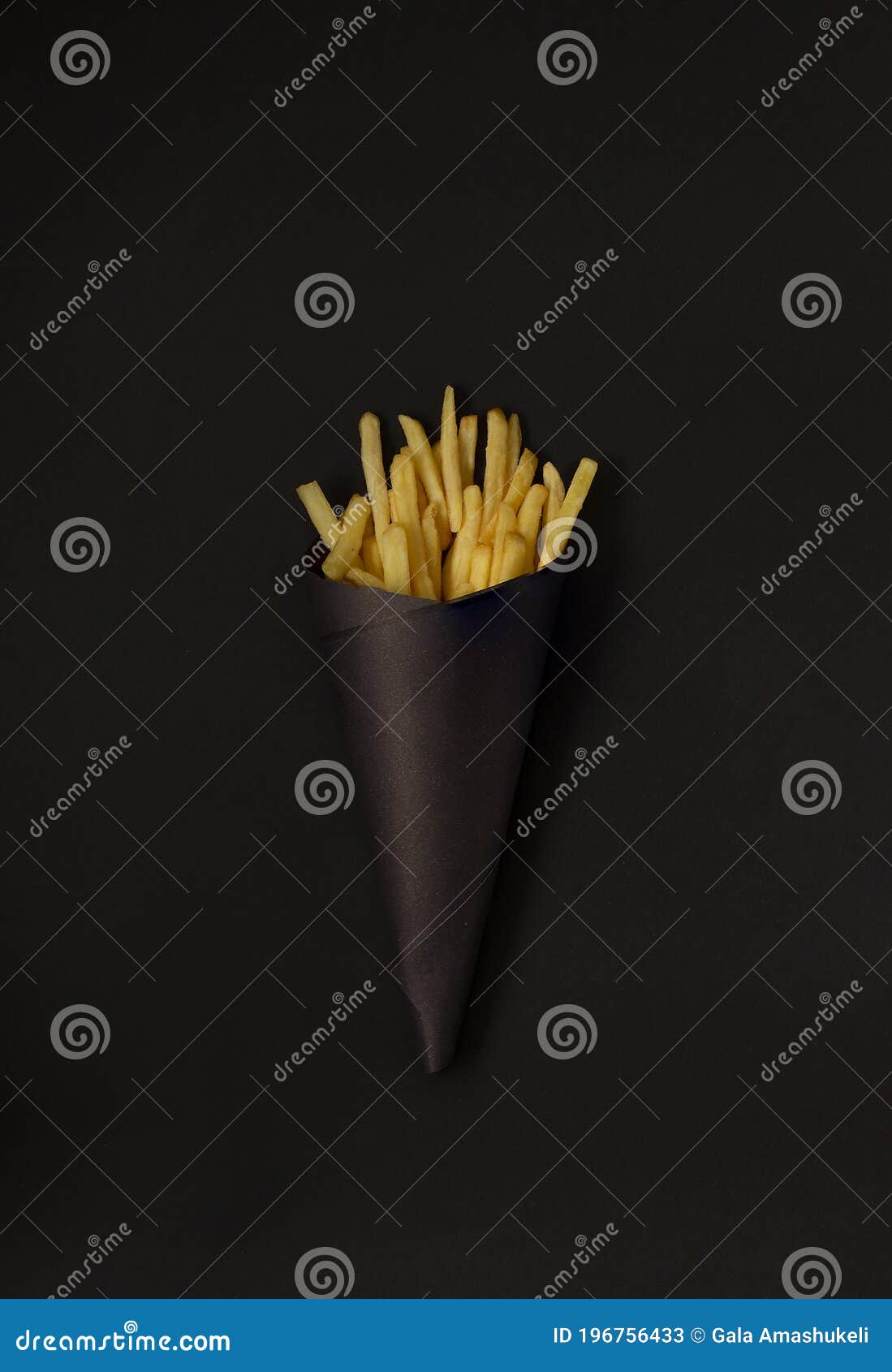 French Fries on a Black Background, in a Black Package, Vertical Stock ...