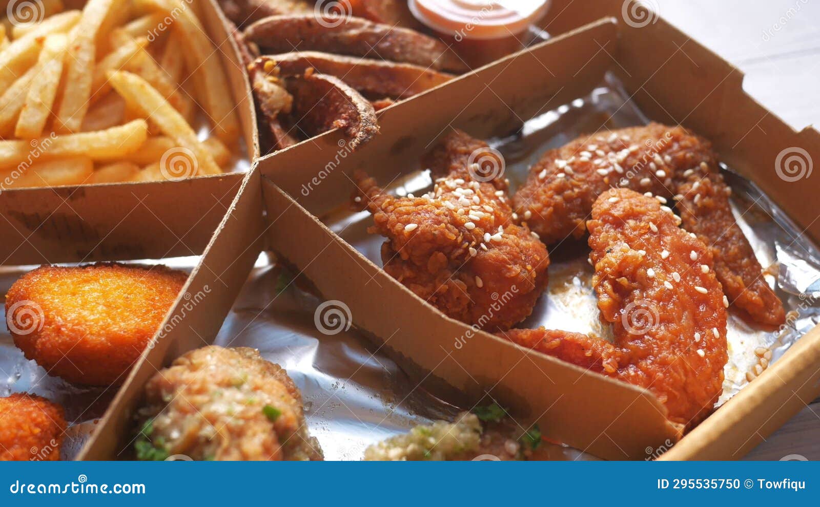 French Fries or Chips and Chicken Wings in a Takeaway Packet Stock ...
