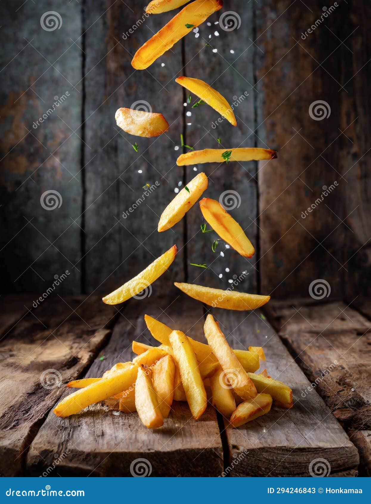 French Fries Falling Down on an Old Rustic Wooden Table Stock ...