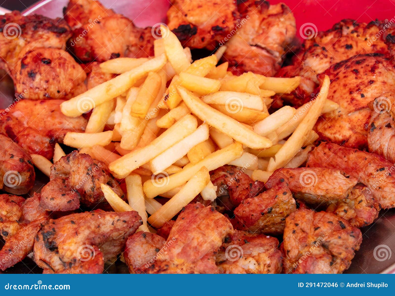 French fries on fried meat stock photo. Image of sauce - 291472046