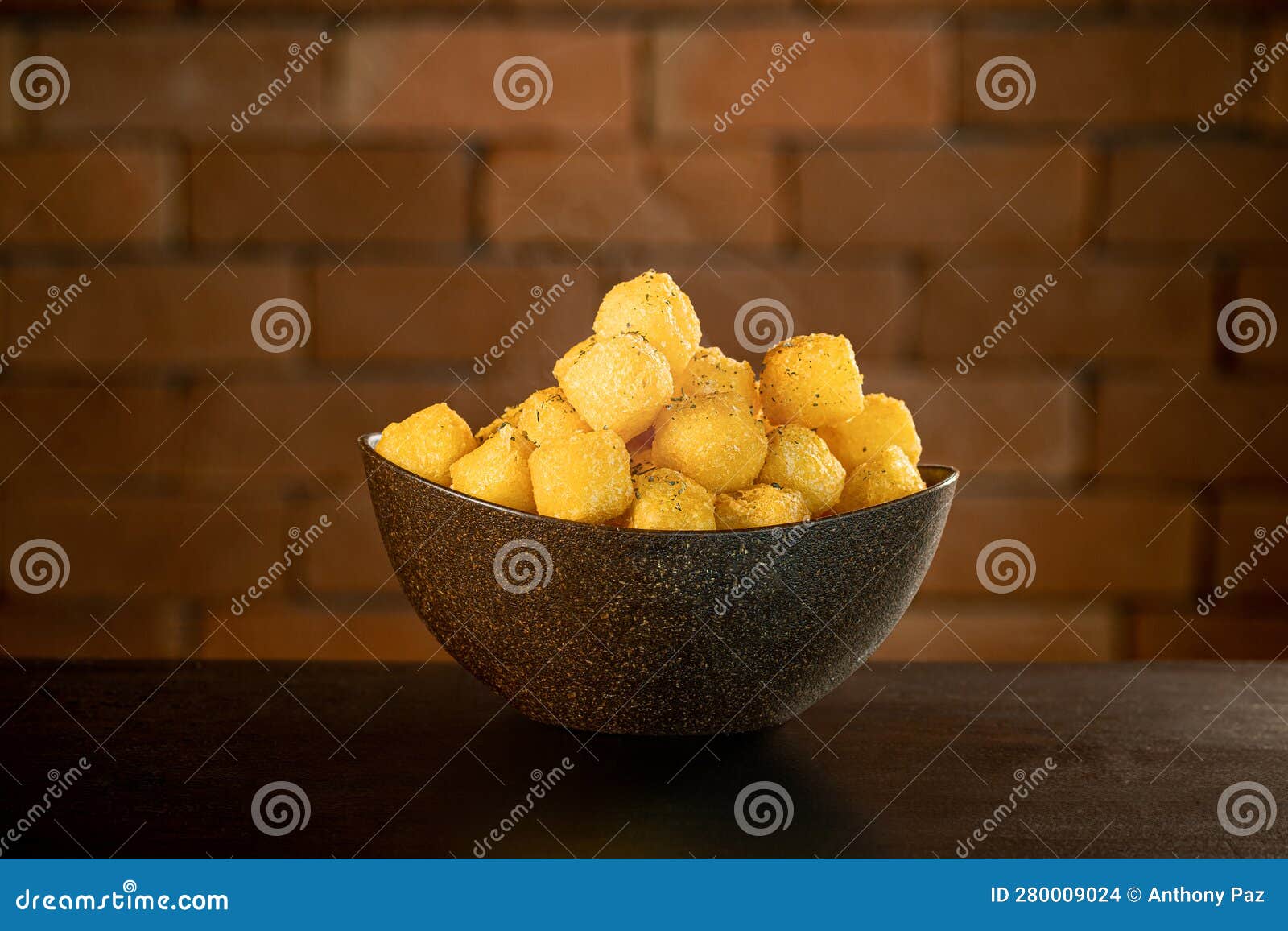 French Fries in Pot on Table in Front of Brick Wall Stock Photo - Image ...