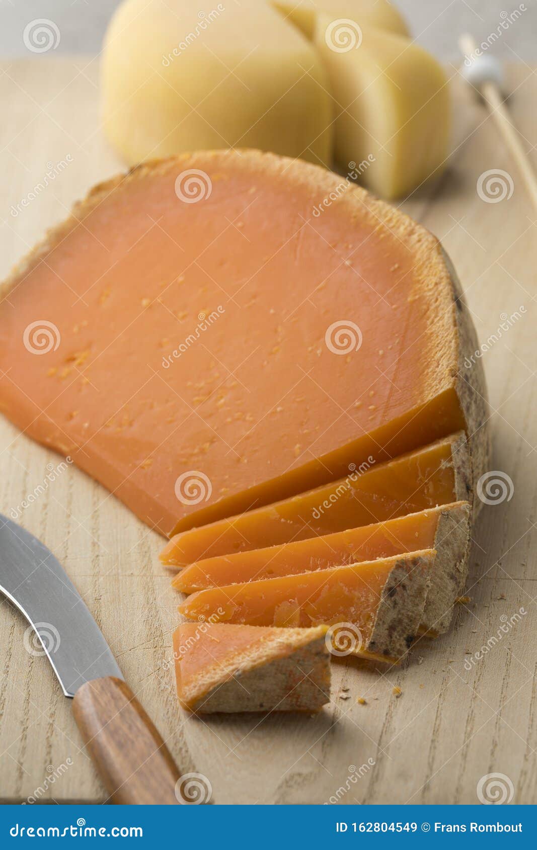 French Mimolette Cheese on a Cutting Board Stock Image - Image of ...