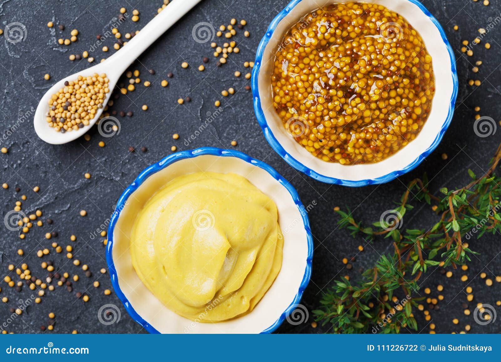 French Mustard and Dijon Mustard on Stone Kitchen Table Top View. Stock ...