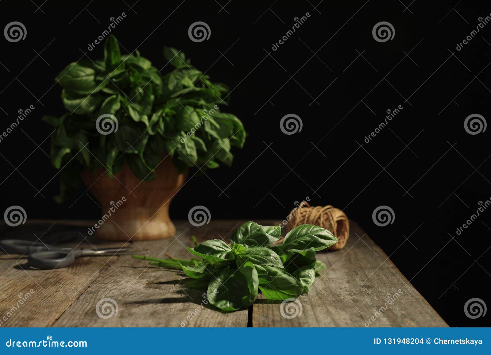 Fresh Basil Leaves on Wooden Table Against Black Background. Stock ...