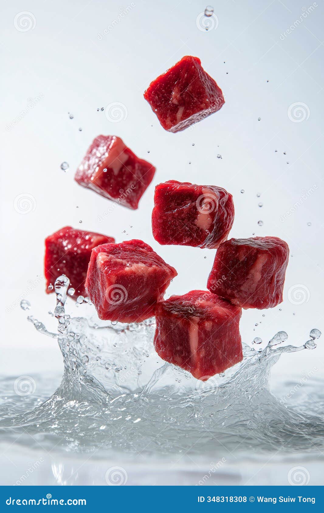 Fresh Beef Cubes Splashing into Water on White Background Stock ...
