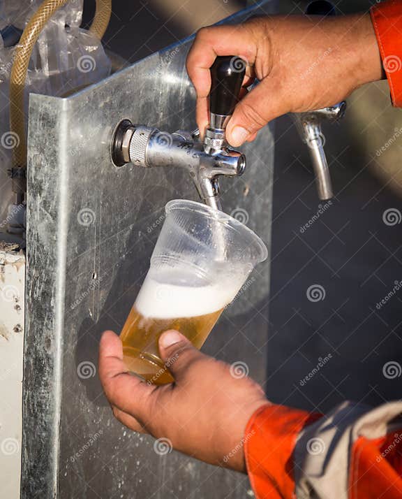 Fresh Beer in a Plastic Cup in the Hand Stock Image - Image of hand ...