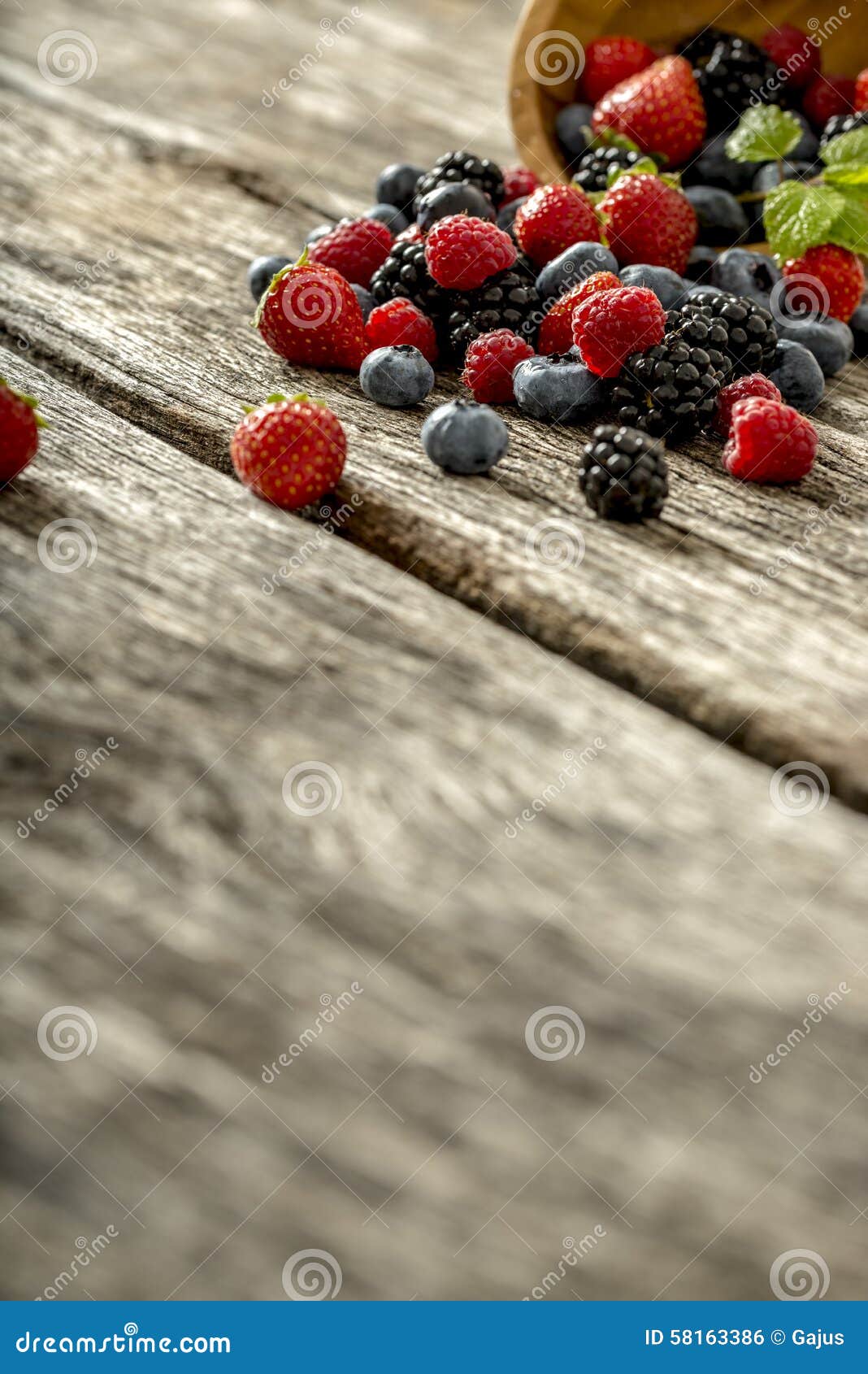 Fresh Berries Spilling from a Bowl Stock Photo - Image of healthy, copy ...