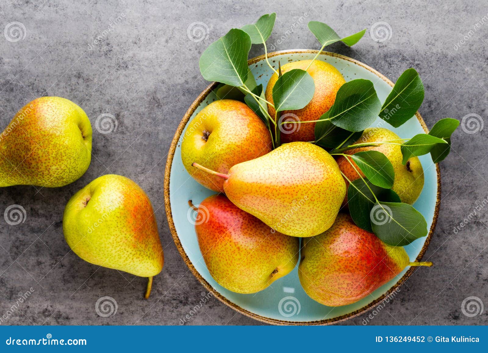 Fresh Bio Pear with Leaves on the Plate. Gray Stone Table Stock Photo ...