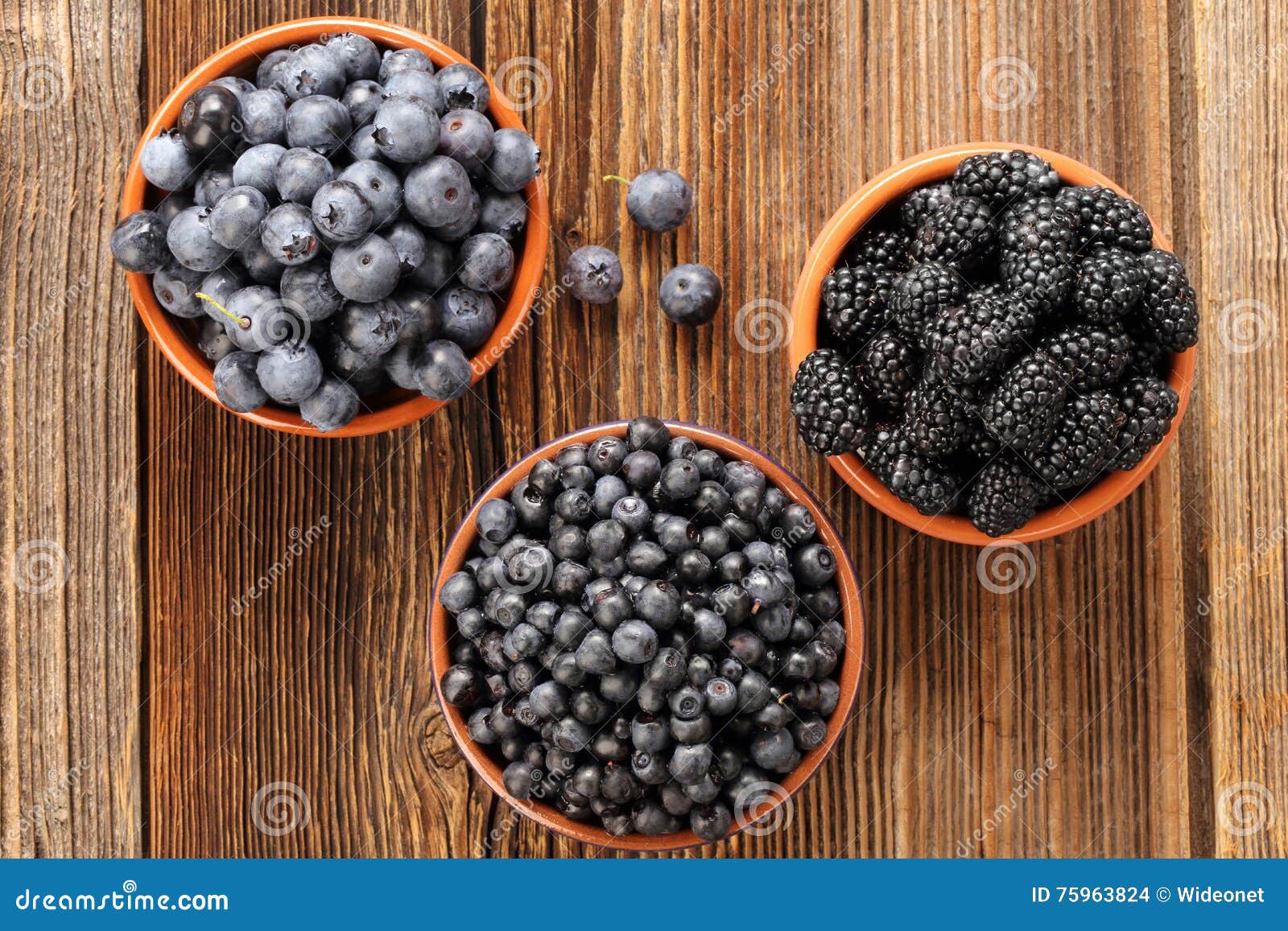 Fresh Blueberries And Blackberries On Old Wooden Background Stock Photo ...