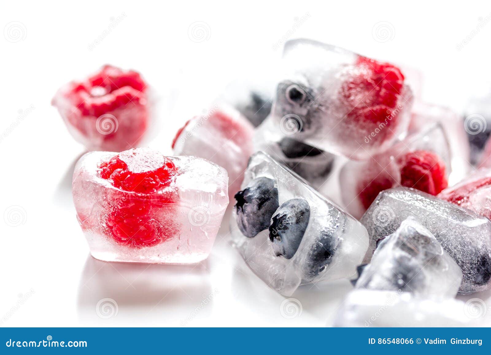 Fresh Blueberry and Raspberry in Ice on Table Background Stock Photo ...