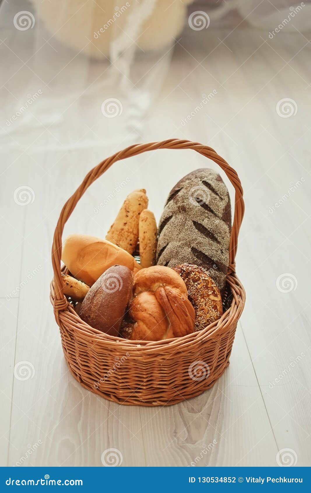 Fresh Bread in a Basket on a Light Background Standing on the Floor ...