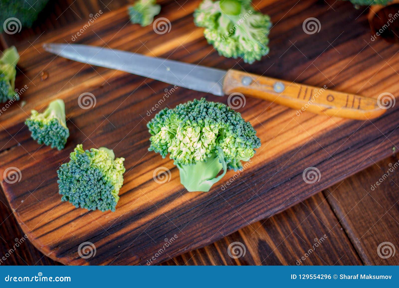 Fresh Broccoli Cutted on the Kitchen Board by Knife. Stock Photo ...